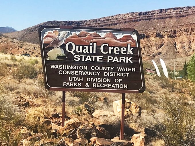 The entrance sign: where expectations are set, adventures begin, and the promise of blue water in red desert becomes wonderfully real.