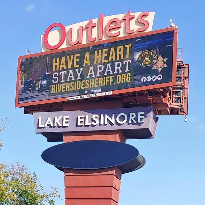 The landmark sign announces your arrival at the promised land of discounts, where full retail prices go to meet their markdown maker.