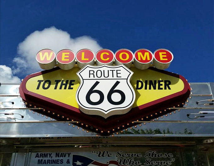 That vintage neon sign welcoming you to Route 66 Diner is basically issuing an invitation you can't refuse.