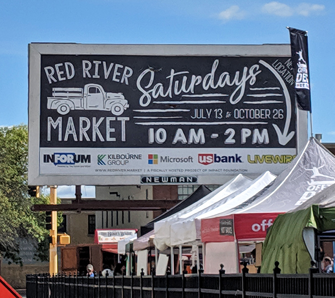 The market's vintage-style signage announces its summer schedule like a friendly invitation to the best weekly party in Fargo.