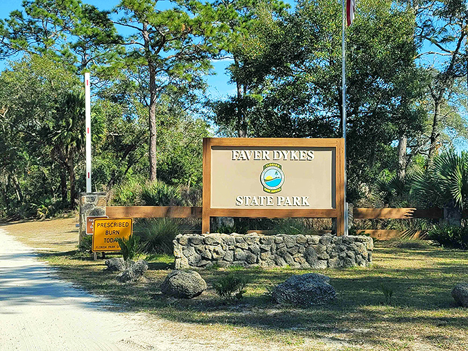 The entrance sign stands like a humble gatekeeper, never hinting at the spectacular natural show waiting just beyond.