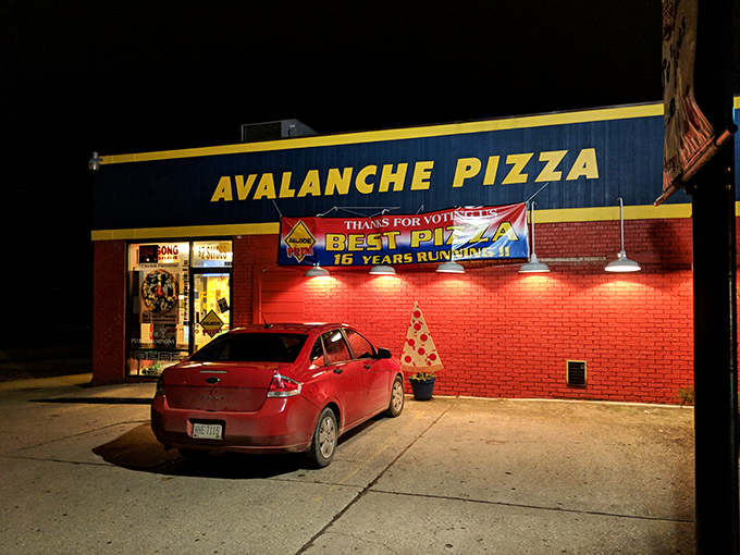 Even at night, Avalanche Pizza's glow serves as a beacon for the hungry, promising satisfaction until the late hours.