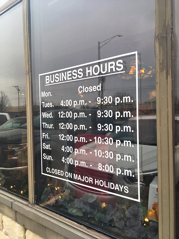 Business hours posted like a promise: "Yes, we're closed Mondays because even Italian food deserves a day of rest."