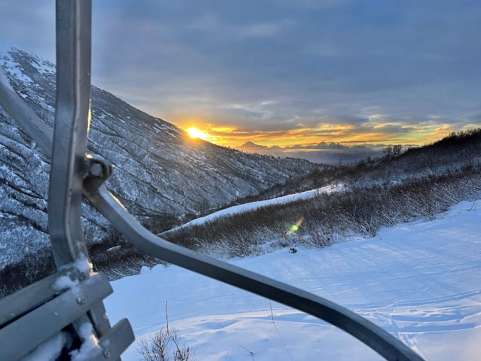 Sunset from the chairlift paints the valley in gold and amber. Even the most jaded travelers fall silent when Alaska puts on its evening light show.