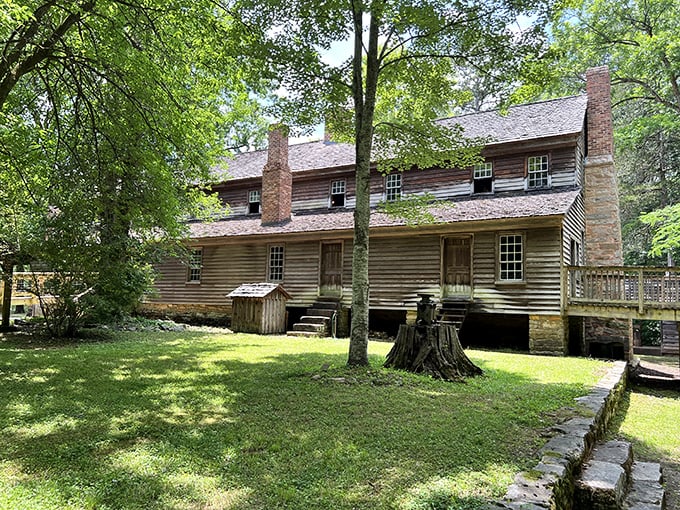 This historic homestead whispers tales from another century, its weathered logs and twin chimneys standing strong against time's passage.