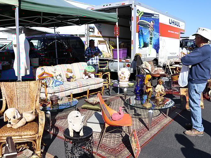 Mid-century furniture dreams come true as shoppers eye that perfect statement piece. The U-Haul in the background isn't just optimism&mdash;it's necessity!