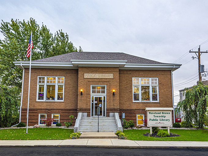 The Waveland Public Library stands proud in its brick finery, a temple to knowledge that's been serving brain food since before the internet.