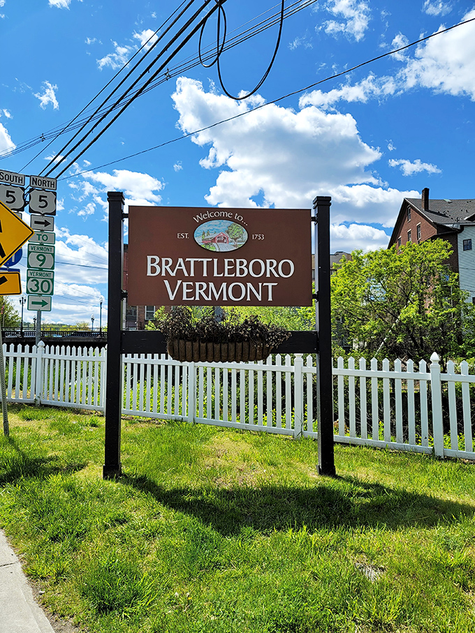 Brattleboro's welcome sign greets visitors with small-town warmth, the white picket fence a perfect frame for Vermont's most affordable slice of paradise.