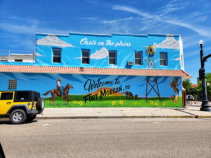 Oasis on the plains indeed! This vibrant mural welcomes visitors with the colorful promise of small-town adventures.