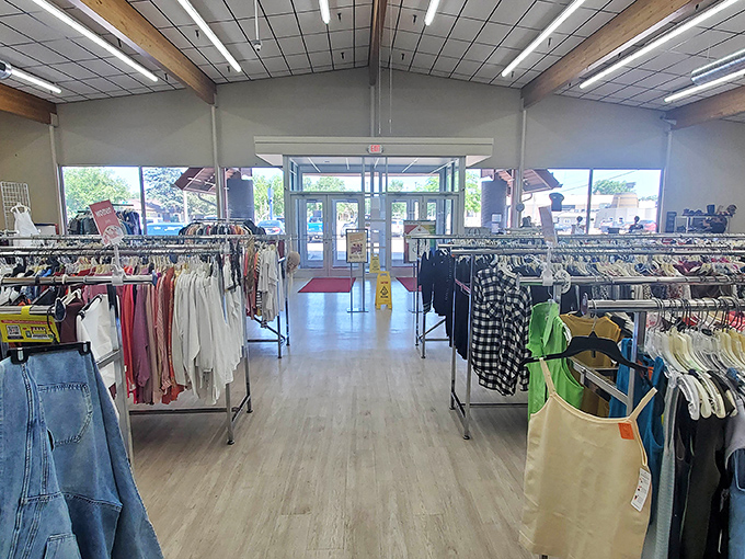 The well-organized clothing section stretches toward the entrance like a runway of possibilities, each rack a potential source of that perfect "I can't believe I found this" moment.