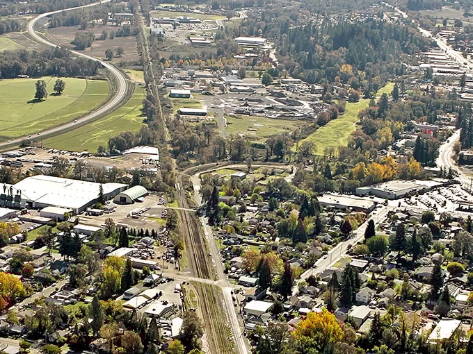 This aerial view reveals Willits nestled in Mendocino's verdant embrace, a town where your retirement dollars stretch further than the horizon.