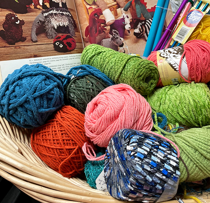 A basket of colorful yarn balls looks like a confectioner's display of exotic sweets. Each skein holds potential scarves, hats, and creative projects waiting to be unraveled.