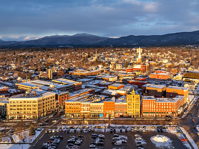 Golden hour bathes downtown Rutland in warm light, highlighting the perfect balance of urban convenience and mountain majesty that defines Vermont living.