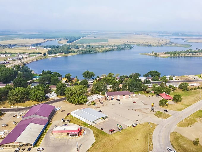 From above, Redfield reveals its perfect positioning alongside shimmering water, surrounded by the patchwork quilt of farmland that defines South Dakota's heartland.
