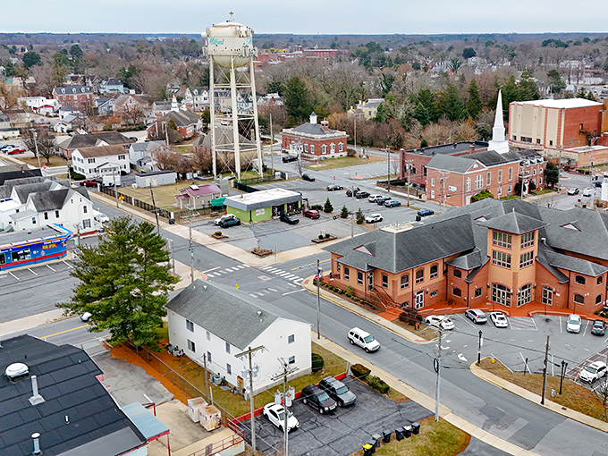 From above, Milford reveals its perfect small-town geometry—historic buildings, tree-lined streets, and that iconic water tower anchoring it all together.