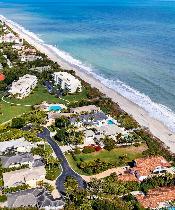 Beachfront properties where residents debate whether to walk on the sand or just admire it from their lanai with morning coffee.