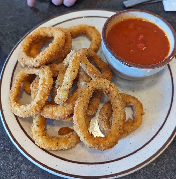 Crispy calamari rings paired with marinara sauce make a fantastic appetizer that disappears faster than you can say "order more."