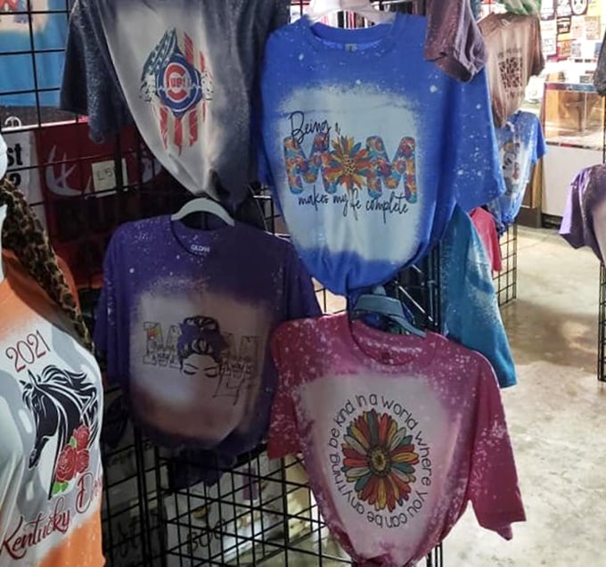 T-shirts that speak their minds hang in colorful rows. Wearable personality statements for every mood, from Cubs fans to flower children. 