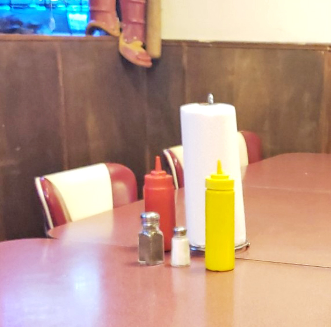 The condiment station&mdash;where the mustard and ketchup bottles stand like sentinels guarding the sacred ritual of personalized flavor enhancement.