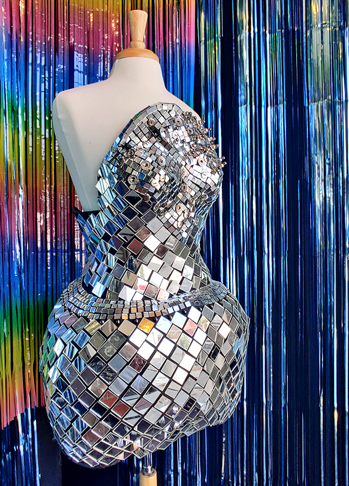 Studio 54 called and wants its dress form back! This mirror-tiled mannequin proves that even thrift stores have their haute couture moments.