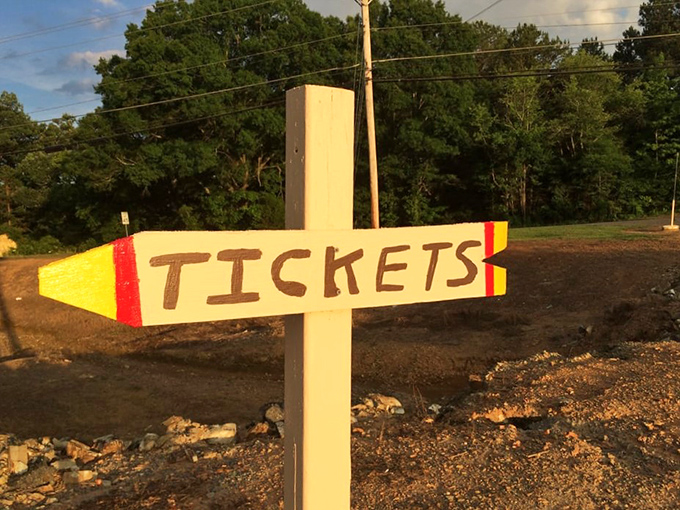 Hand-painted with care, this charming pencil-shaped sign points the way to an evening that's anything but two-dimensional.