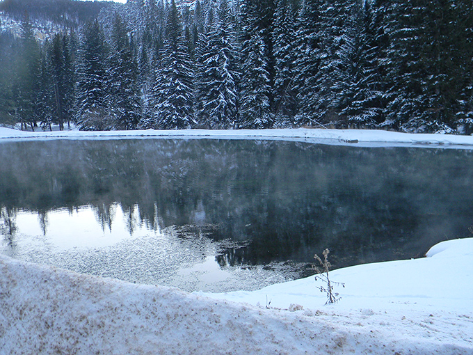 Winter transforms Spearfish into a snow globe scene where steaming waters meet frozen edges in perfect, peaceful contrast.