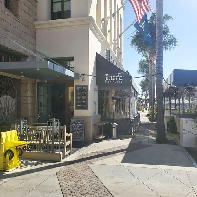 Sunshine bathes the entrance to Lure Fish House, where the sidewalk seems to say, "This way to seafood nirvana." The yellow fire hydrant stands guard, ensuring nothing interrupts your dining experience.