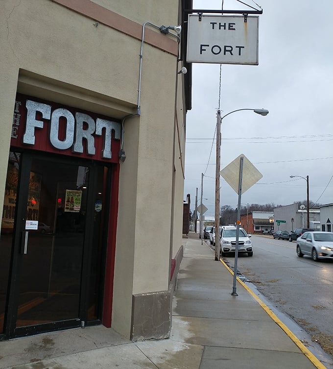 The unassuming entrance to The Fort stands as a culinary beacon in downtown Fort Atkinson, where extraordinary flavors hide behind ordinary doors.