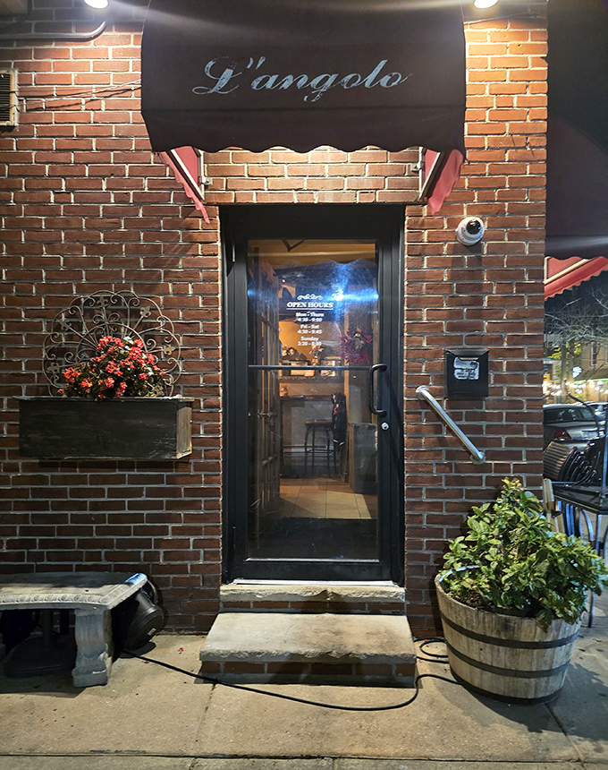 The entrance beckons like a portal to another world. Behind that door lies a symphony of garlic, basil, and tomato that will haunt your dreams.