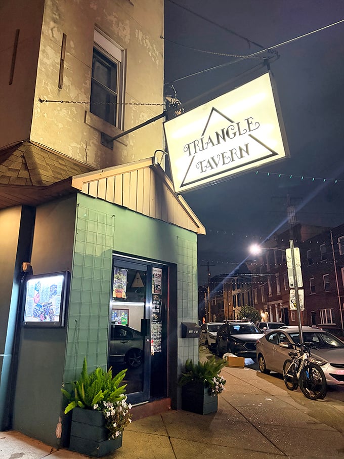 As evening falls, Triangle Tavern's warm glow beckons from the street. Some neighborhood spots just feel like coming home.