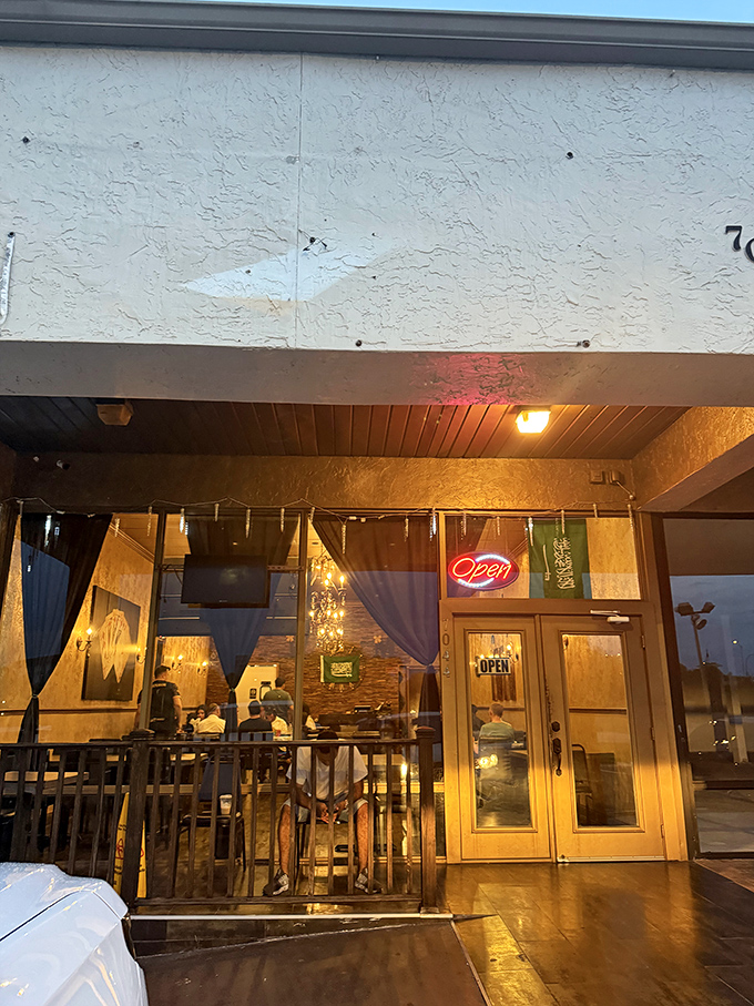 As evening falls, the warm glow from within beckons hungry travelers like a lighthouse for those seeking culinary adventure.