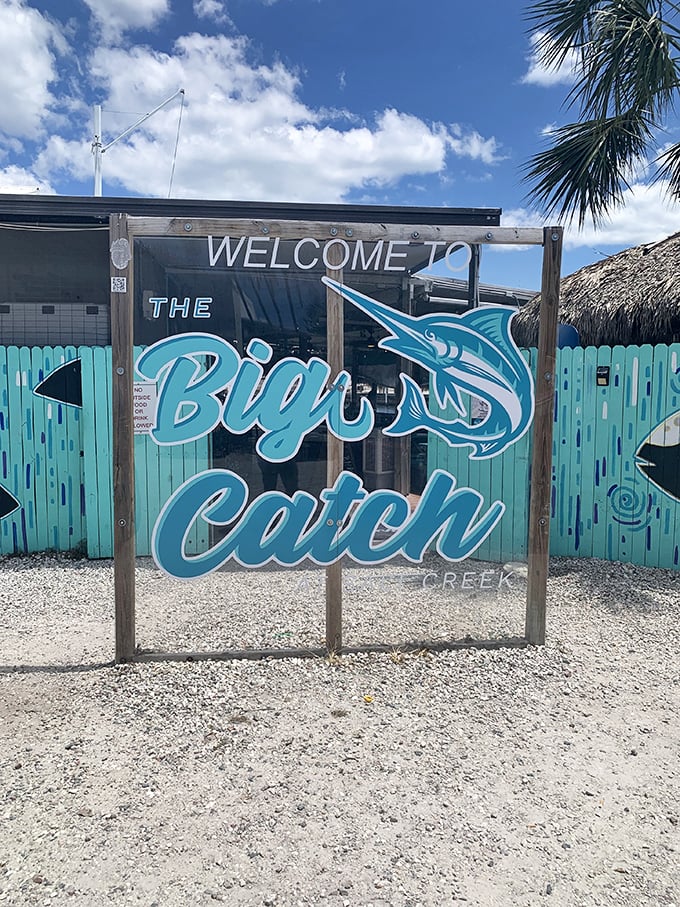 A welcome sign that promises exactly what it delivers &ndash; a big catch of flavor. The turquoise fence sets the tone for the coastal feast that awaits.