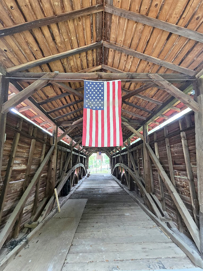The American flag hanging proudly inside adds a patriotic touch to the impressive wooden framework. History and national pride intertwine beneath these beams.