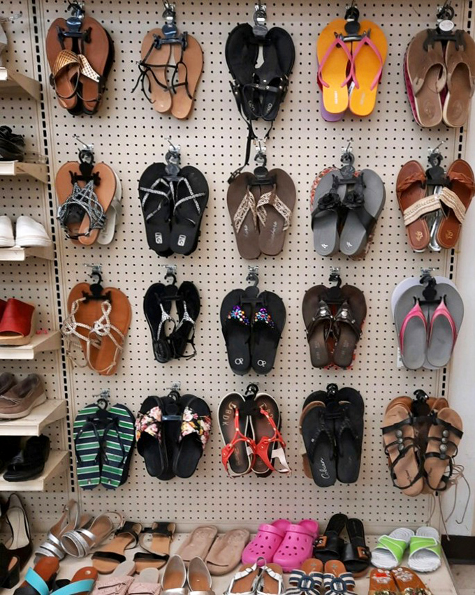 The flip-flop wall&mdash;a vertical beach vacation where summer footwear waits in neat rows for their next sandy adventure.