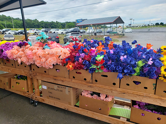 Silk flowers that never wilt, arranged in cardboard boxes like a permanent springtime that laughs in the face of seasonal change.