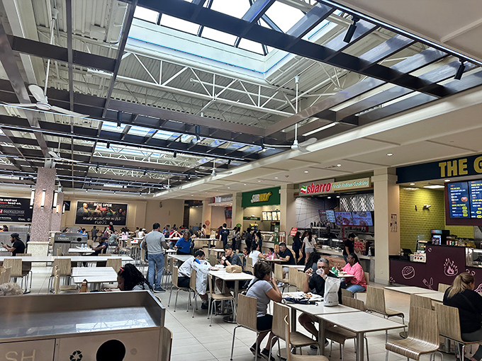 The food court: battlefield of hungry shoppers, where sustenance is acquired before the next retail campaign begins.