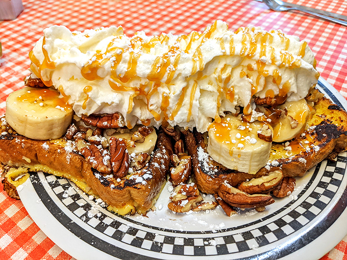 This isn't just French toast&mdash;it's a sweet skyscraper of morning indulgence, where pecans, bananas, whipped cream and caramel create a breakfast skyline worth admiring.