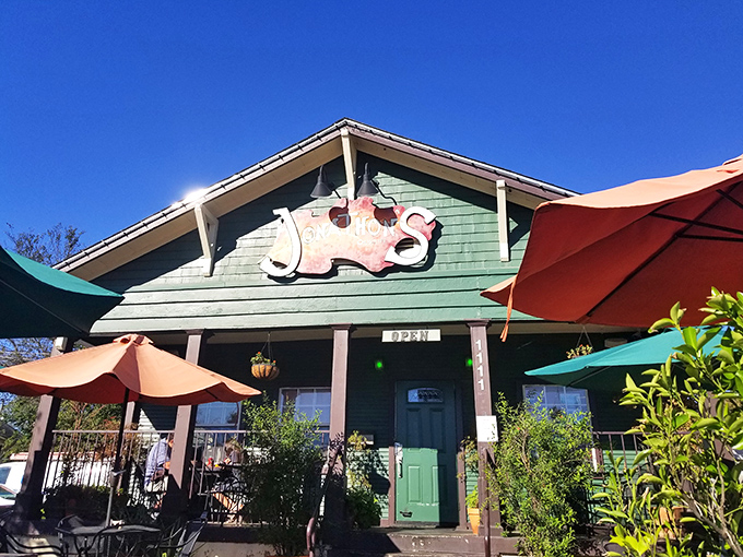 Those red umbrellas on the patio say "Come sit, stay cool, and eat something that'll make you smile."