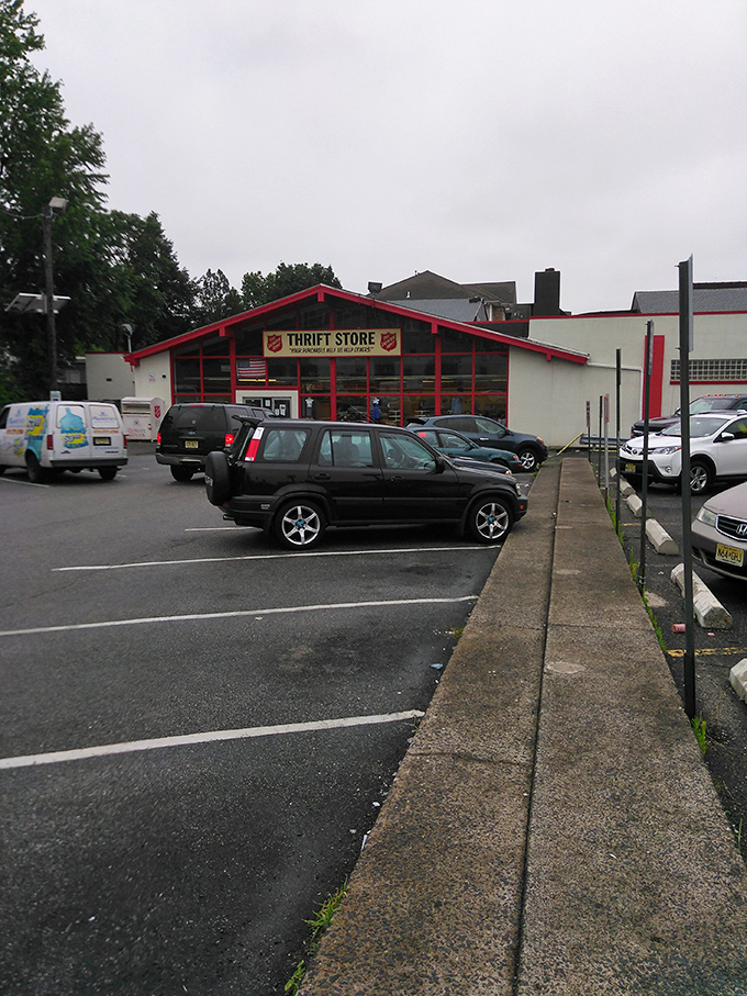 From this angle, the store looks like a red-trimmed portal to possibility. Each car in this lot represents someone's thrifting journey.