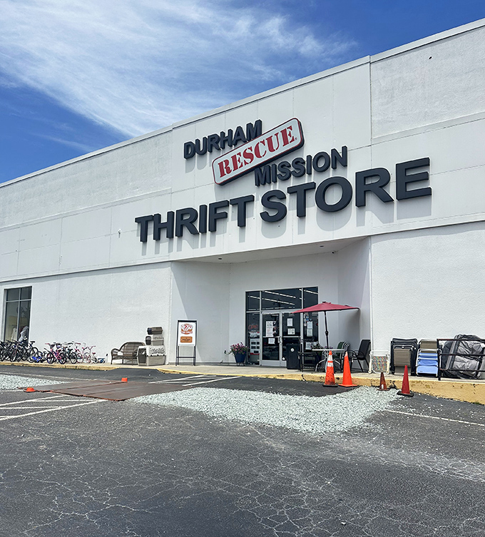 Blue skies frame the entrance where bicycles and outdoor furniture hint at the variety of treasures waiting just beyond those doors.