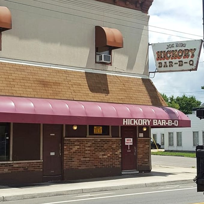 A daytime view reveals the modest storefront that houses extraordinary flavors&mdash;proof that culinary greatness doesn't require fancy facades.