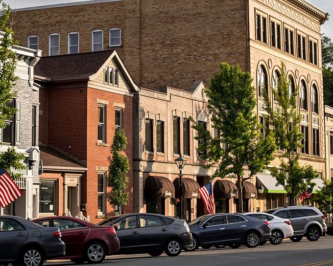 Historic storefronts maintain their dignity through decades, housing businesses where "the usual" still means something personal.