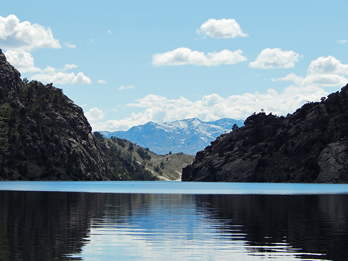 A perfect frame of mountain peaks through canyon walls &ndash; nature's way of saying "I do windows" with spectacular results.