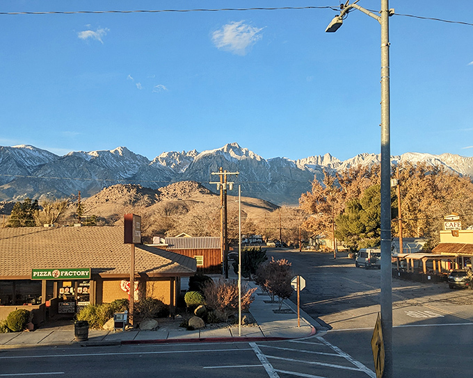 Golden hour transforms an ordinary intersection into a postcard moment. The Sierra Nevada mountains glow like they're illuminated from within.