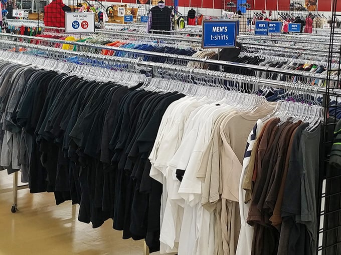 Men's shirts hang in organized rows, ready to upgrade wardrobes without requiring financial counseling sessions afterward. 