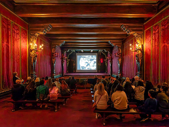 The castle's movie theater glows red with anticipation, ready for guests to experience the ultimate "dinner and a movie" night that puts your local cinema to shame.