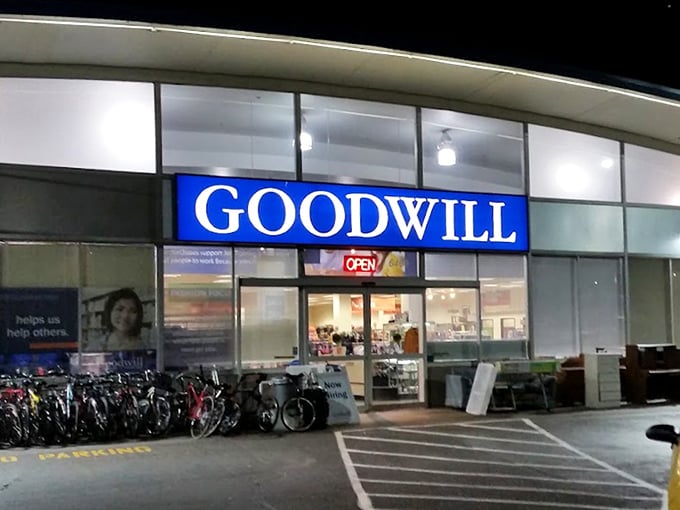 Evening at Goodwill: where the blue sign glows with possibility against the night sky. Tomorrow's vintage finds are waiting just beyond those doors.