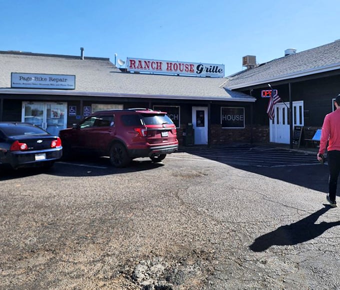Morning light catches the Ranch House Grille sign, where locals' cars in the lot tell you everything you need to know about its reputation.