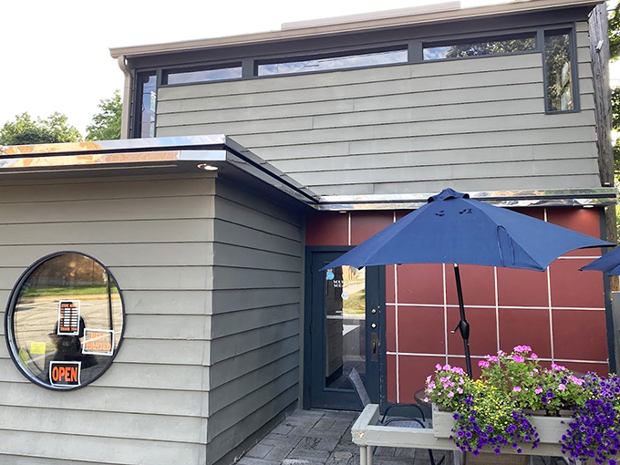 The entrance says "come as you are" while those purple flowers add a touch of "we actually care." Midwestern hospitality in architectural form.