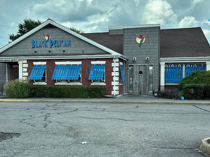 Even under moody skies, that blue-shuttered facade stands out like a coastal landmark. The pelican logo practically guarantees seafood worth writing home about.